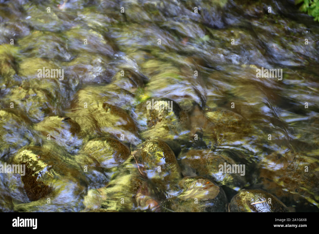 Running water over stones at a coastal beach location Stock Photo - Alamy