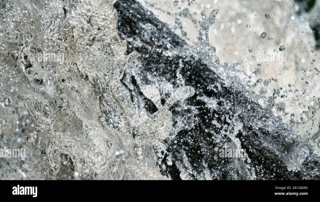 Water backgrounds with foam spray fast flow.The log is stuck in ...