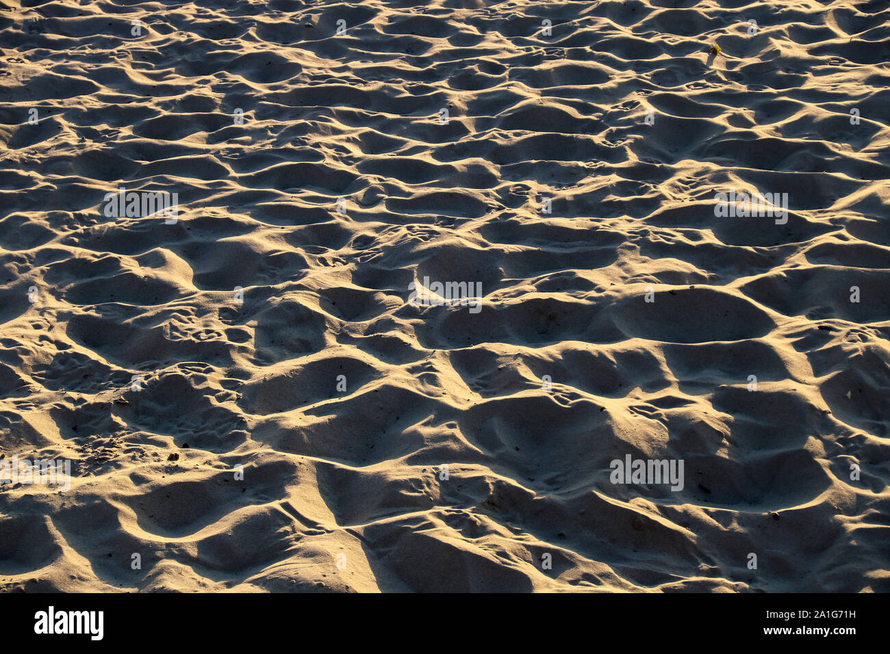 Rippled sand at a sunlit coastal beach Stock Photo - Alamy