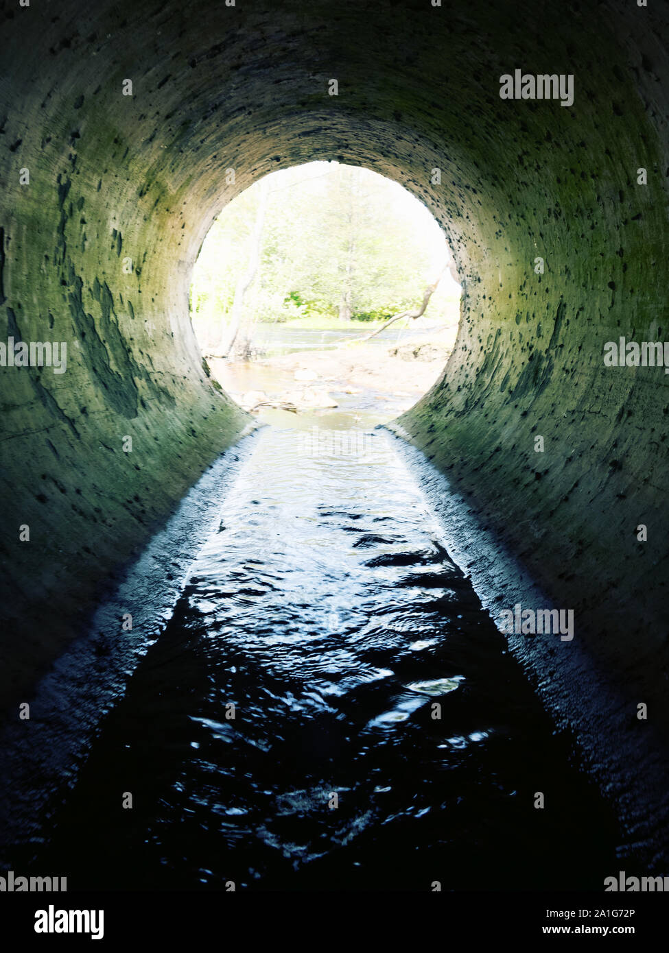 Drainage pipe under the highway (culvert). Filming inside the pipe ...
