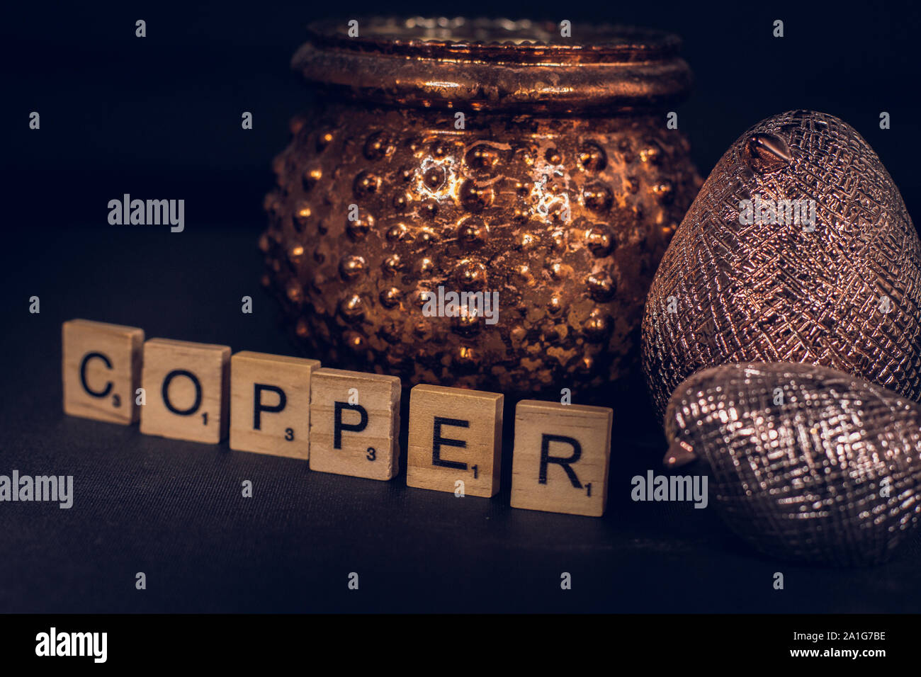 2 copper decor birds and a small candle pot in coppery colors with the ...