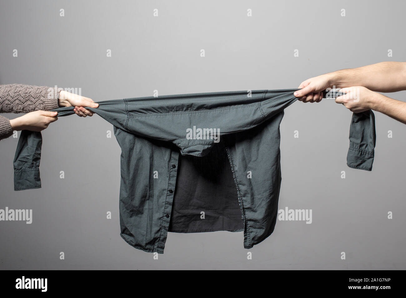 man and woman hungrily snatch each other's hand clothes, and tearing it ...