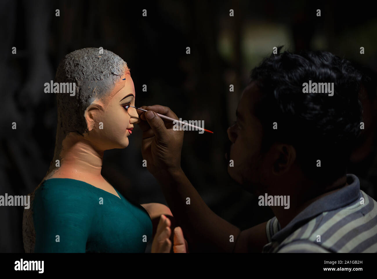 An artist works on a statue of goddess durga ahead of the festival ...