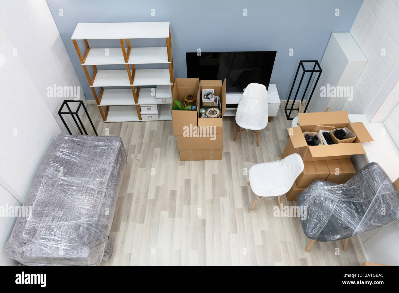 Living Room Interior Of New House With Moving Boxes Stock Photo - Alamy