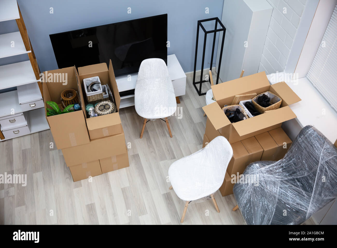 Living Room Interior Of New House With Moving Boxes Stock Photo - Alamy