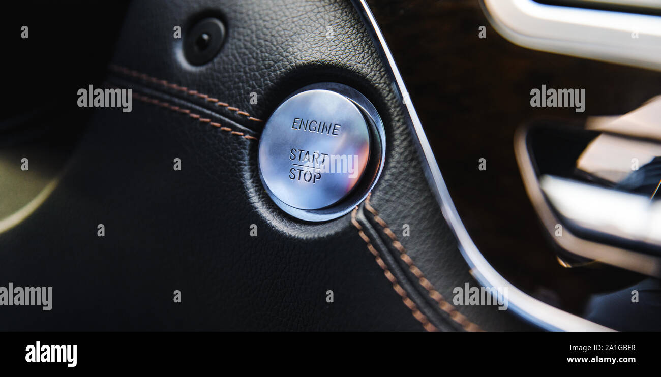 start-stop button engine on a leather base of a business car with ...