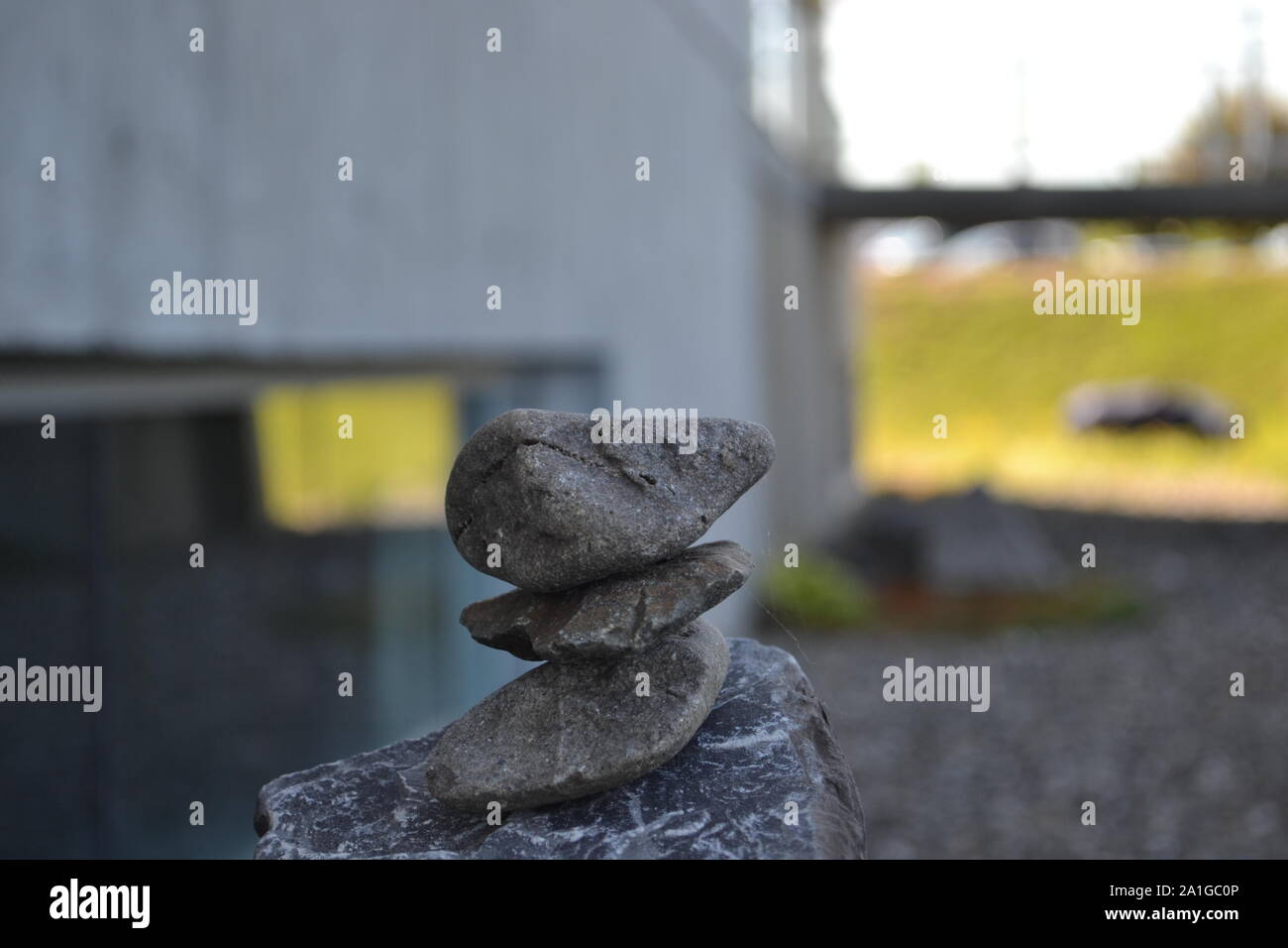 Three rocks on a rock Stock Photo - Alamy