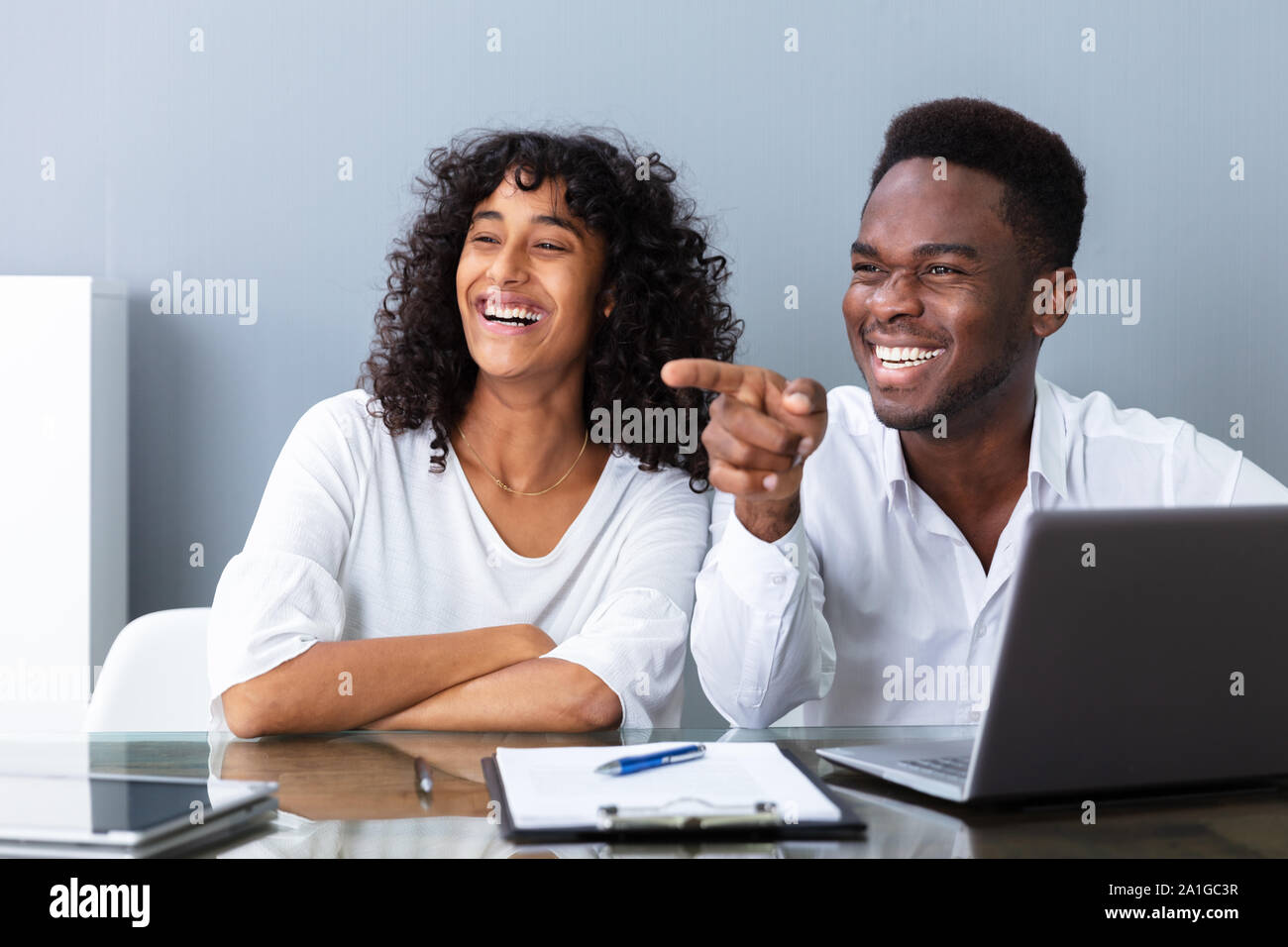 People Laughing About Their Coworker In Office Stock Photo - Alamy