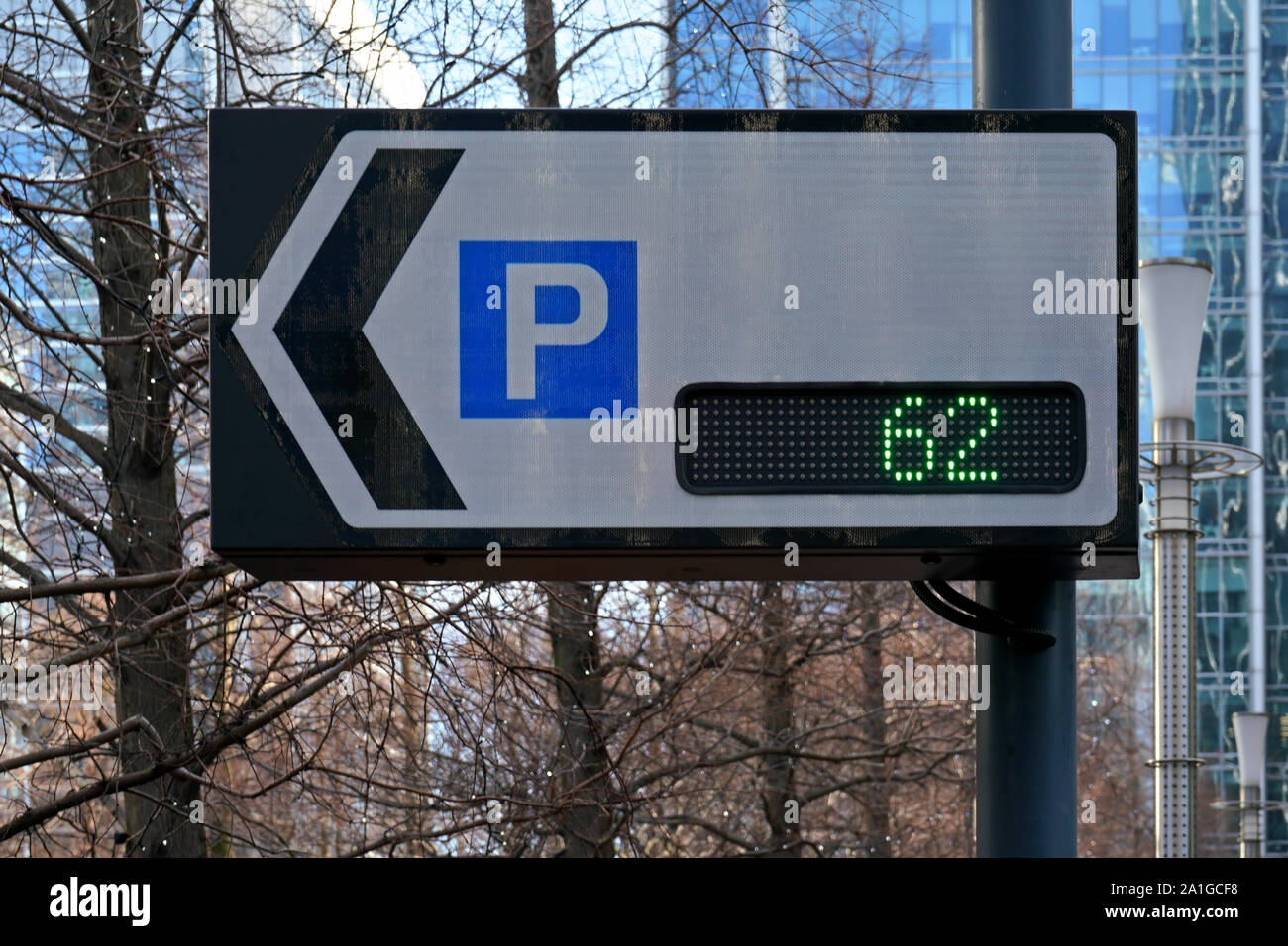 Traffic sign board showing number of parking spaces and arrow pointing ...