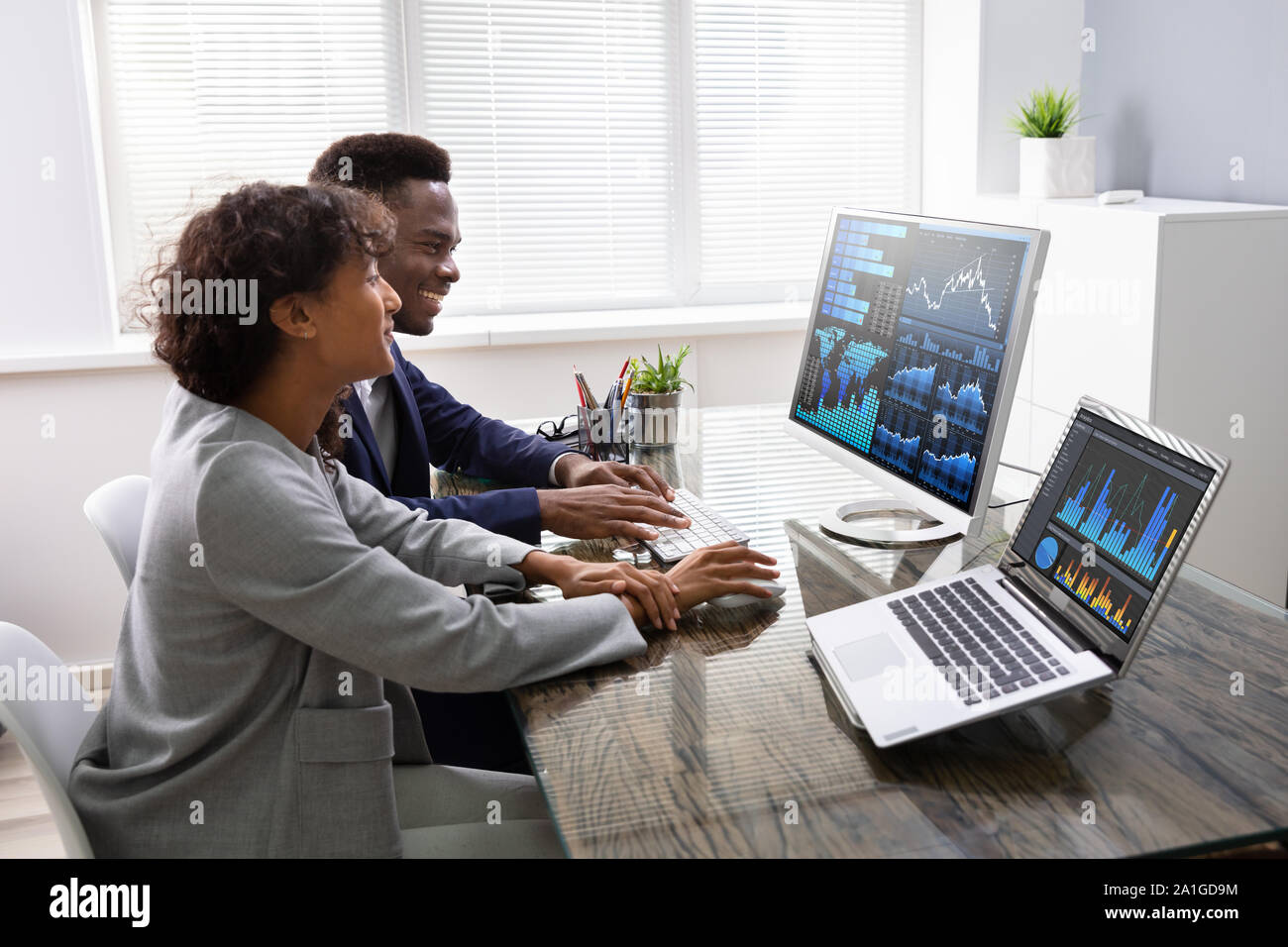 Stock Market Broker Analyzing Graphs On Computer In Office Stock Photo ...