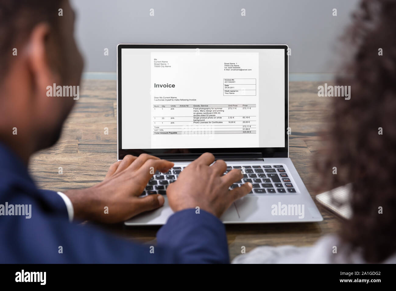 Two businesspeople analyzing invoice hi-res stock photography and ...