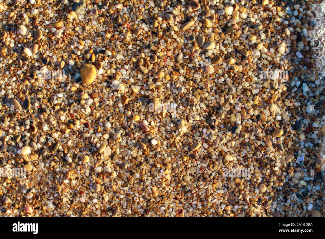 sea pebbles colored granite on the beach background stones. The shore ...