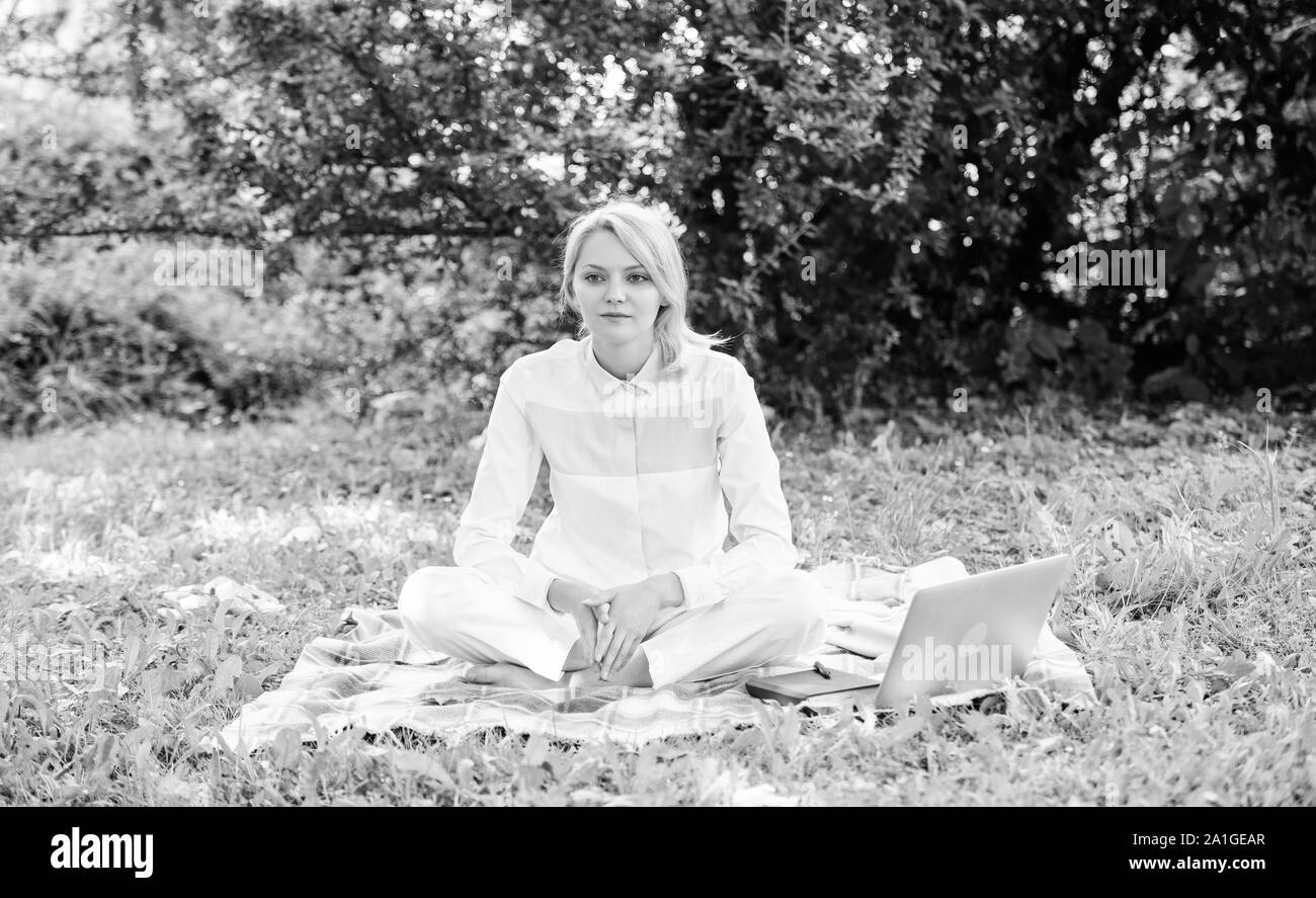Woman with laptop or notebook sit on rug green grass meadow. Business ...