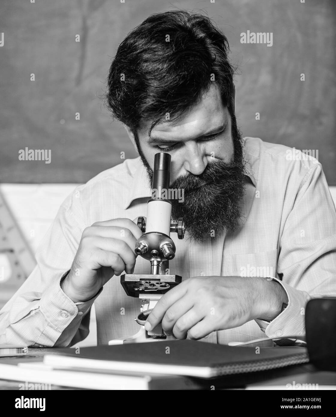 Set up microscope. Teacher sit desk with microscope. Man bearded ...