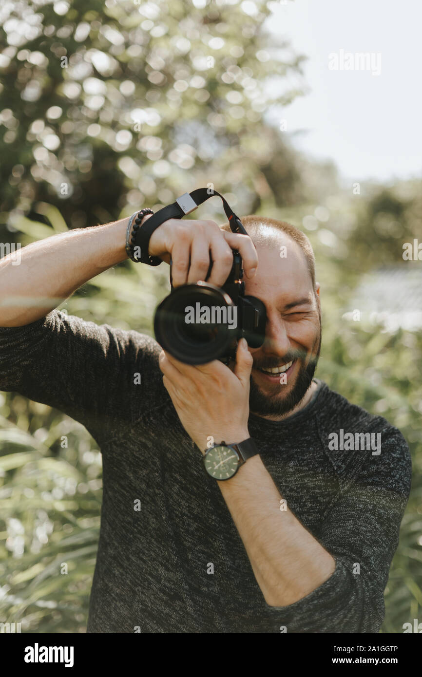 Happy photographer is taking a photo Stock Photo - Alamy