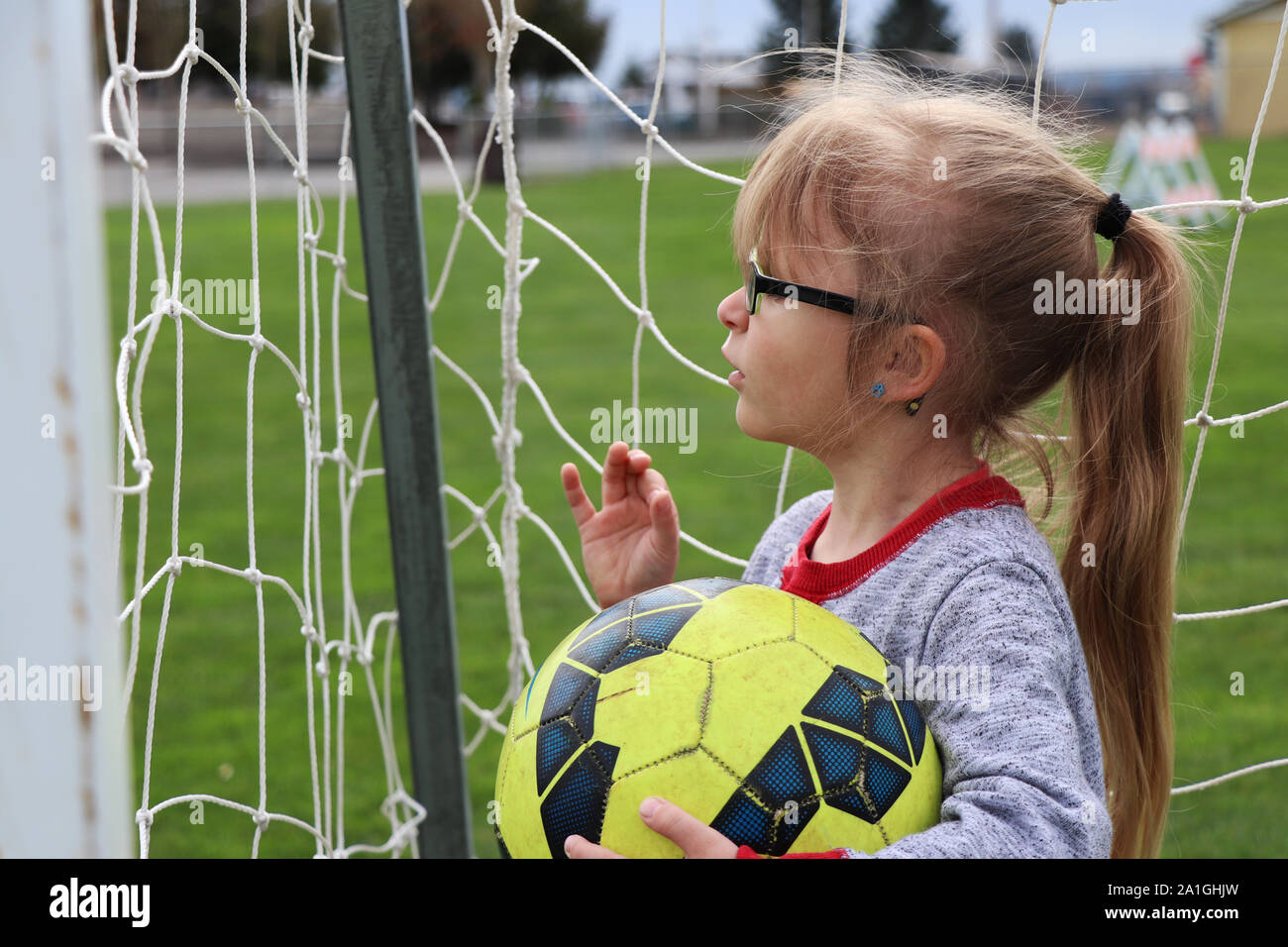 Young child taking a break from playing soccer Stock Photo - Alamy