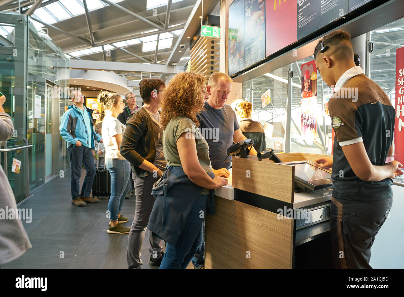 COLOGNE, GERMANY - CIRCA OCTOBER, 2018: people queue at a McDonalds's ...