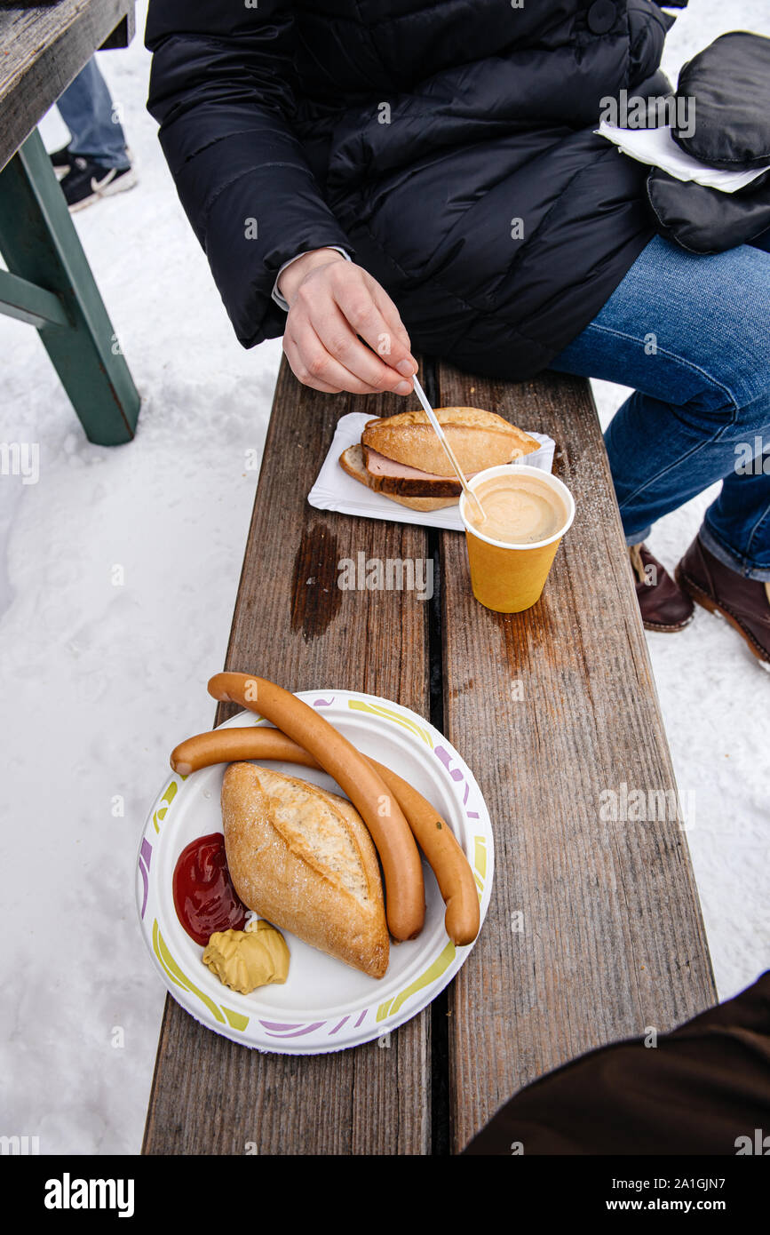 Woman eating traditional German wurst sausage and traditional meat ...