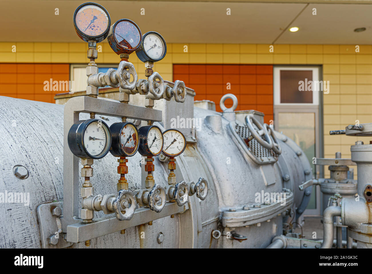 Old rusty damaged metal meter, valve tube system and gas or liquid tank ...