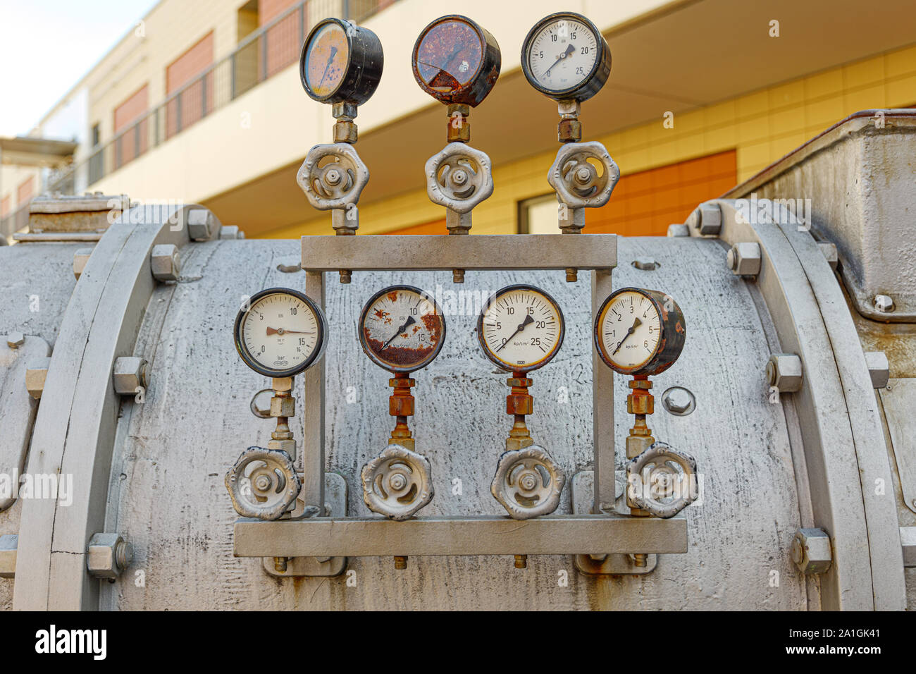 Old rusty damaged metal meter, valve tube system and gas or liquid tank ...