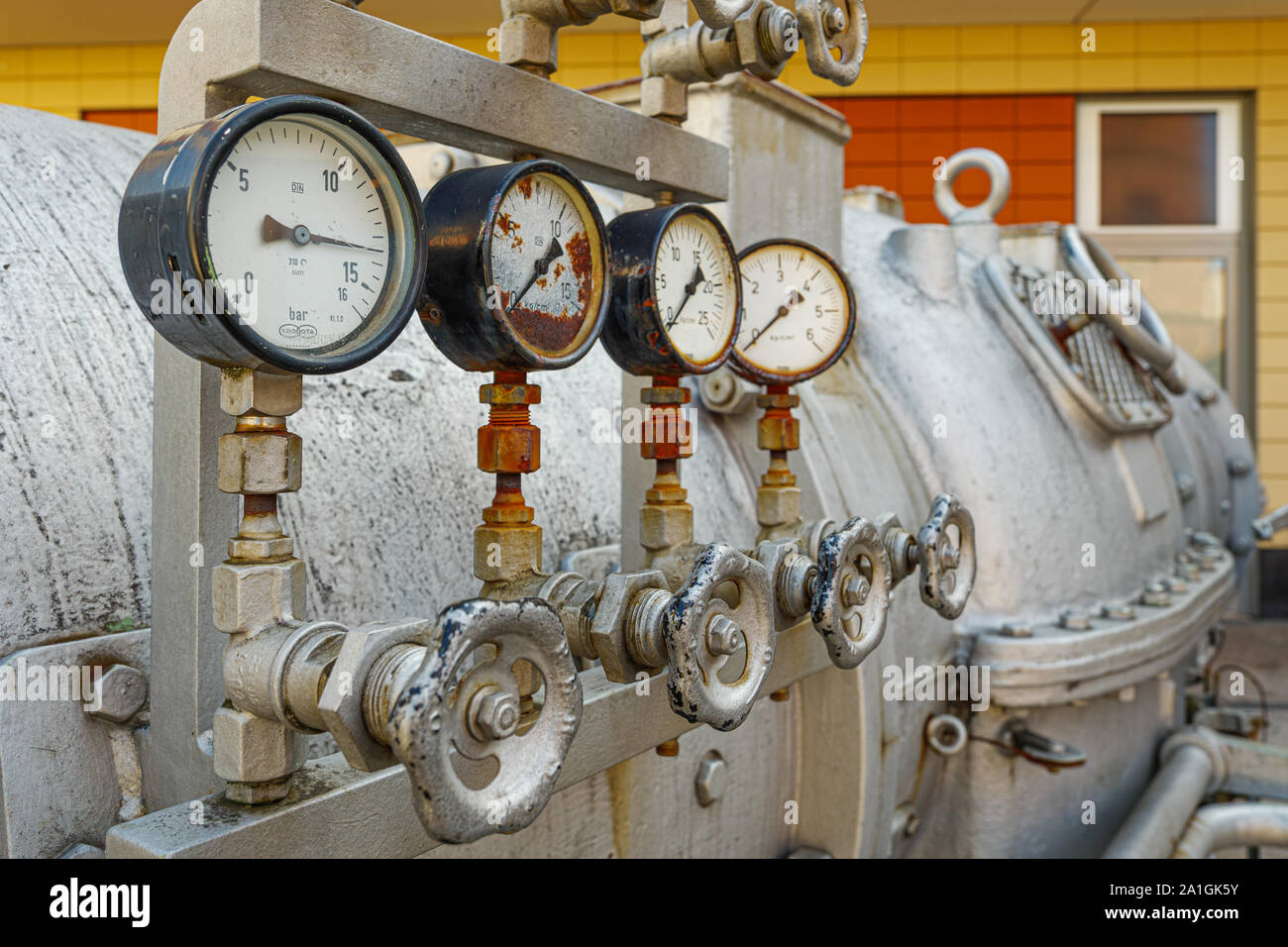 Old rusty damaged metal meter, valve tube system and gas or liquid tank ...