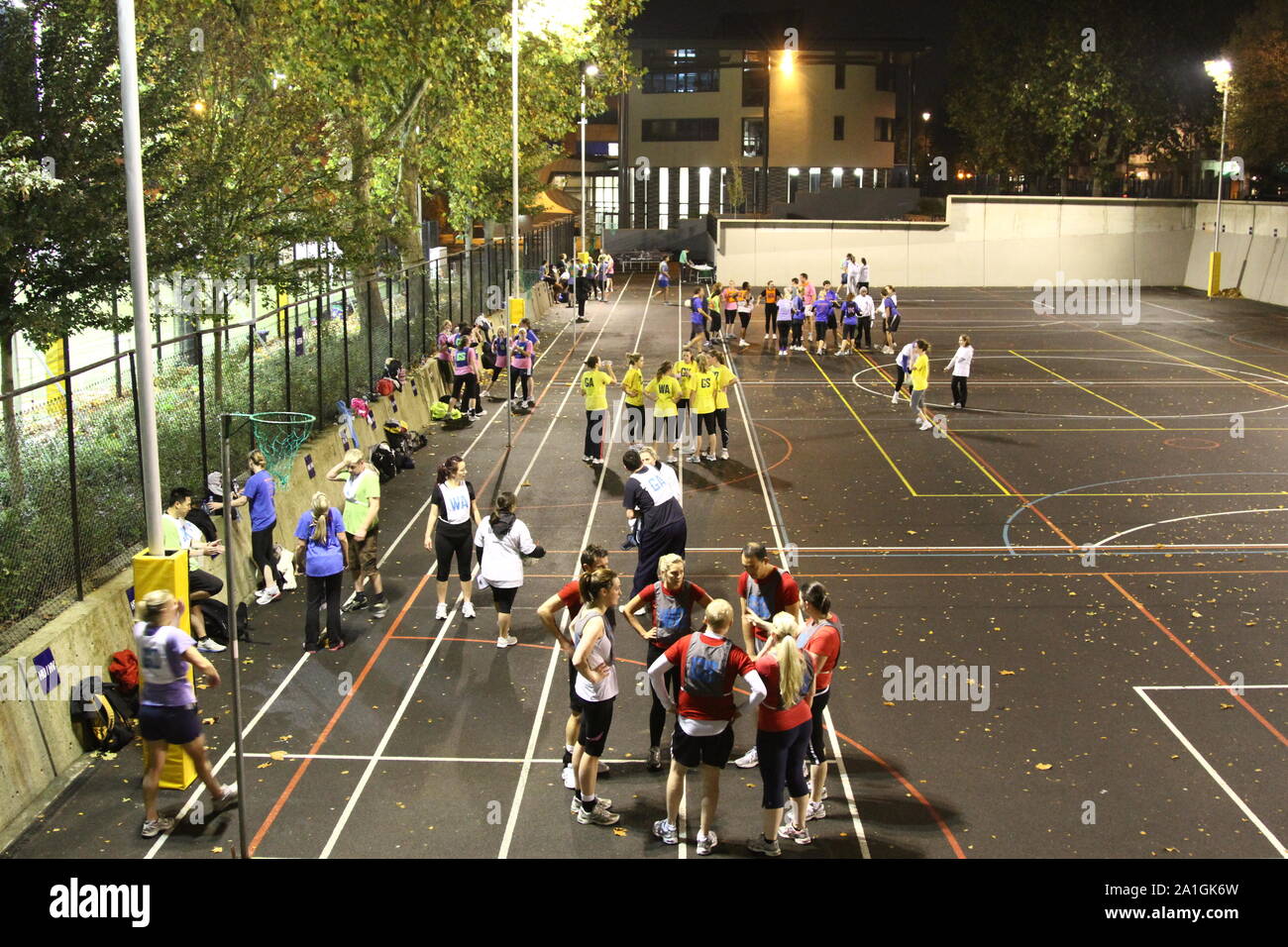Netball teams getting ready for competition training under floodlight ...