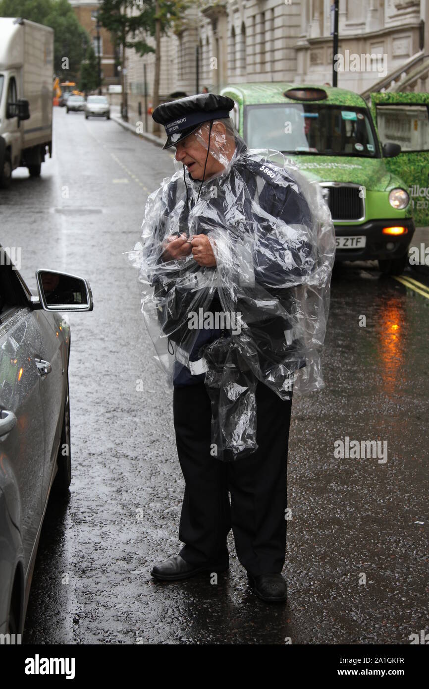Civil enforcement officer on duty on the streets of London. Miserable ...