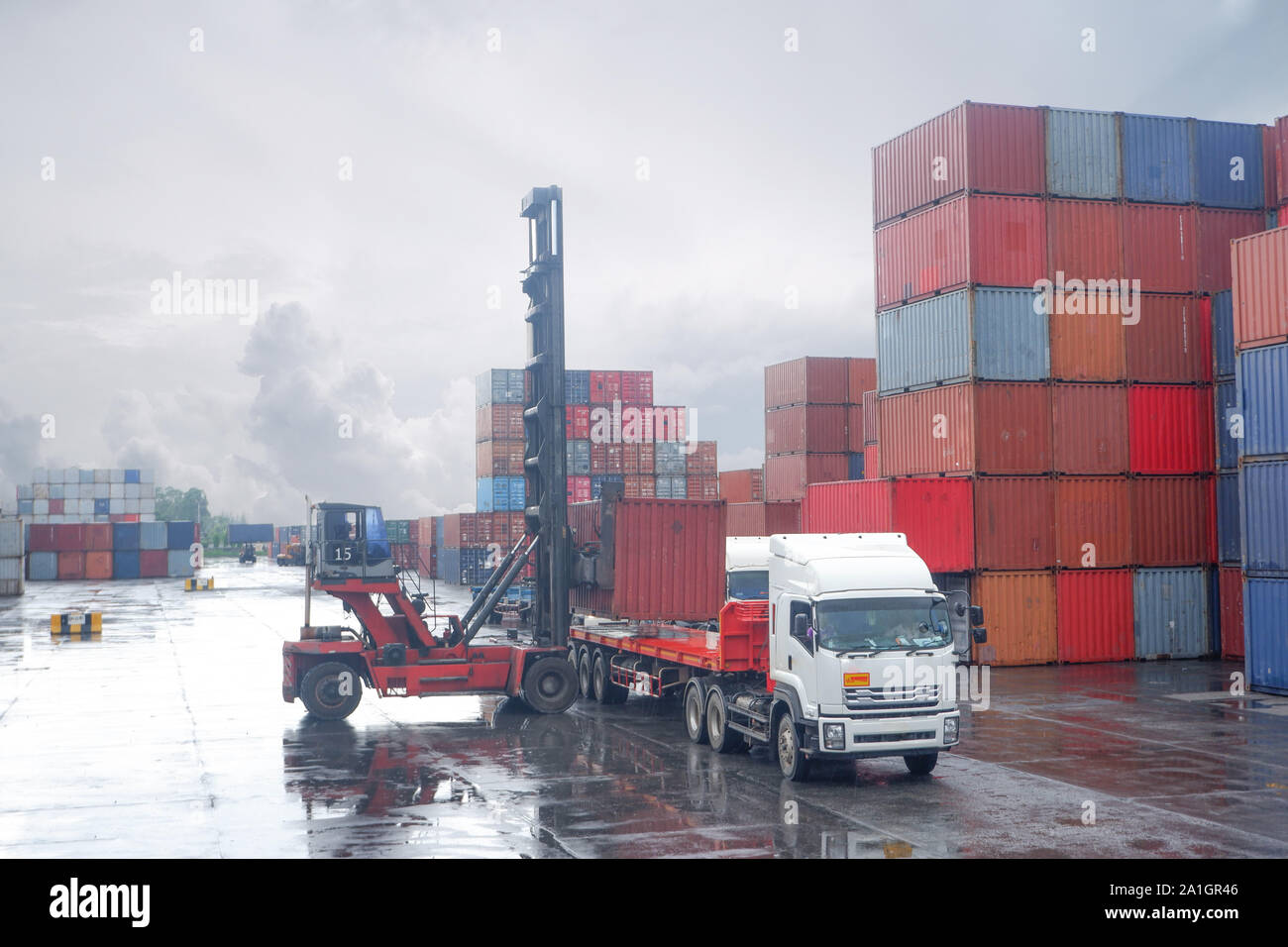 Container handlers Loading containers into trucks Stock Photo - Alamy