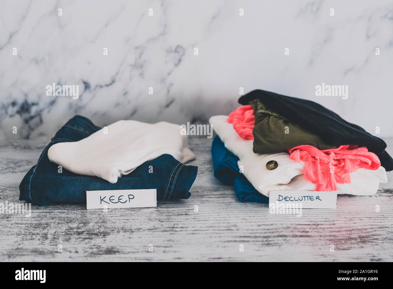 declutter and tidying up concept, fashion clothes folded and stacked ...