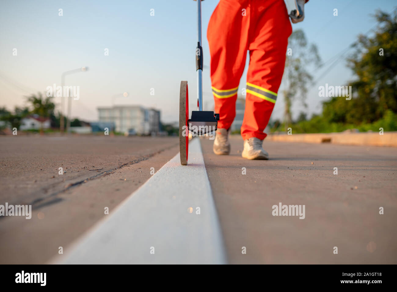 Measuring road distances with a measuring wheel Stock Photo - Alamy