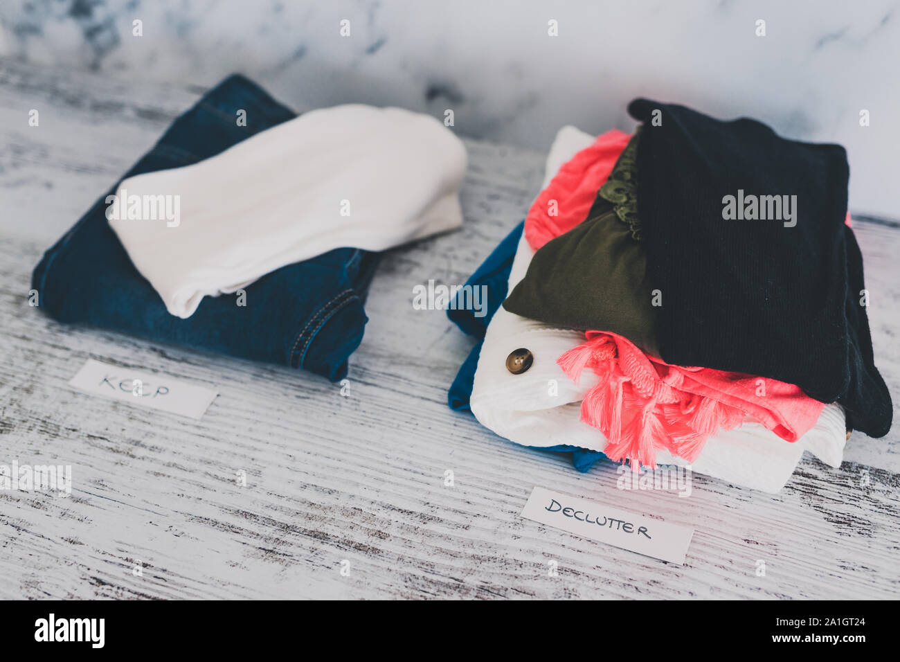 declutter and tidying up concept, fashion clothes folded and stacked ...