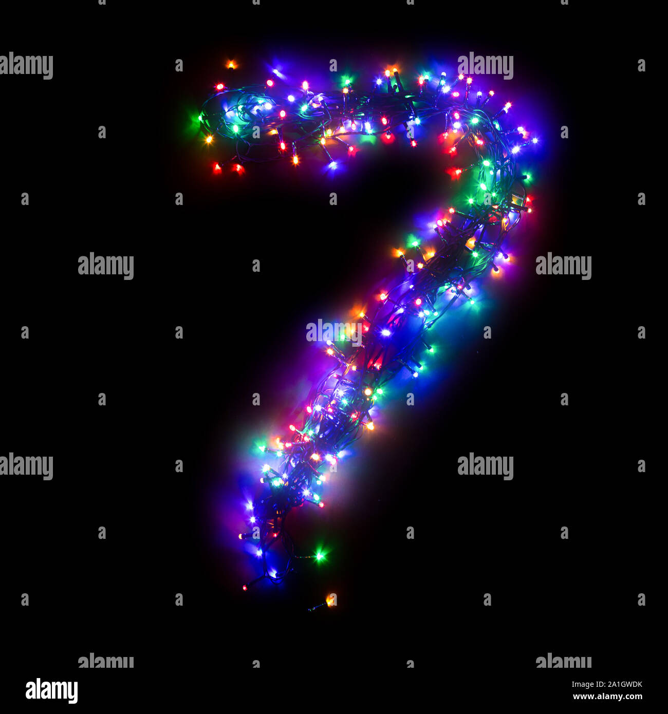 Arabic numeral "7" from a multi-colored electric garland on a black ...
