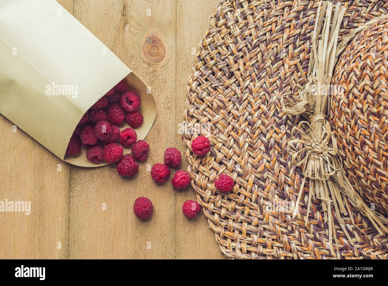 Summer holiday, vacation, relaxation concept. Raspberries, straw hat ...