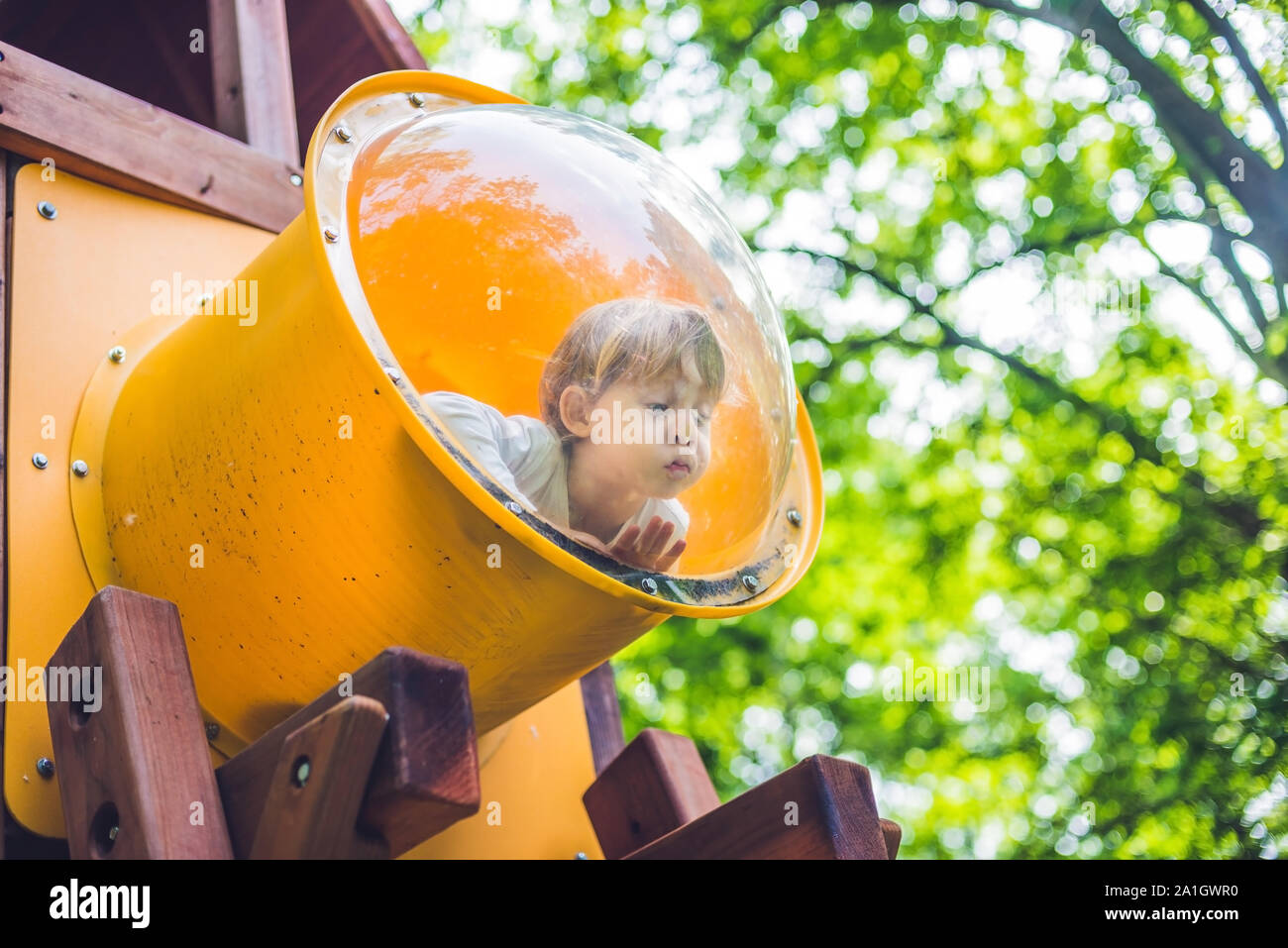 Cute little boy is playing on a wooden playground Stock Photo - Alamy