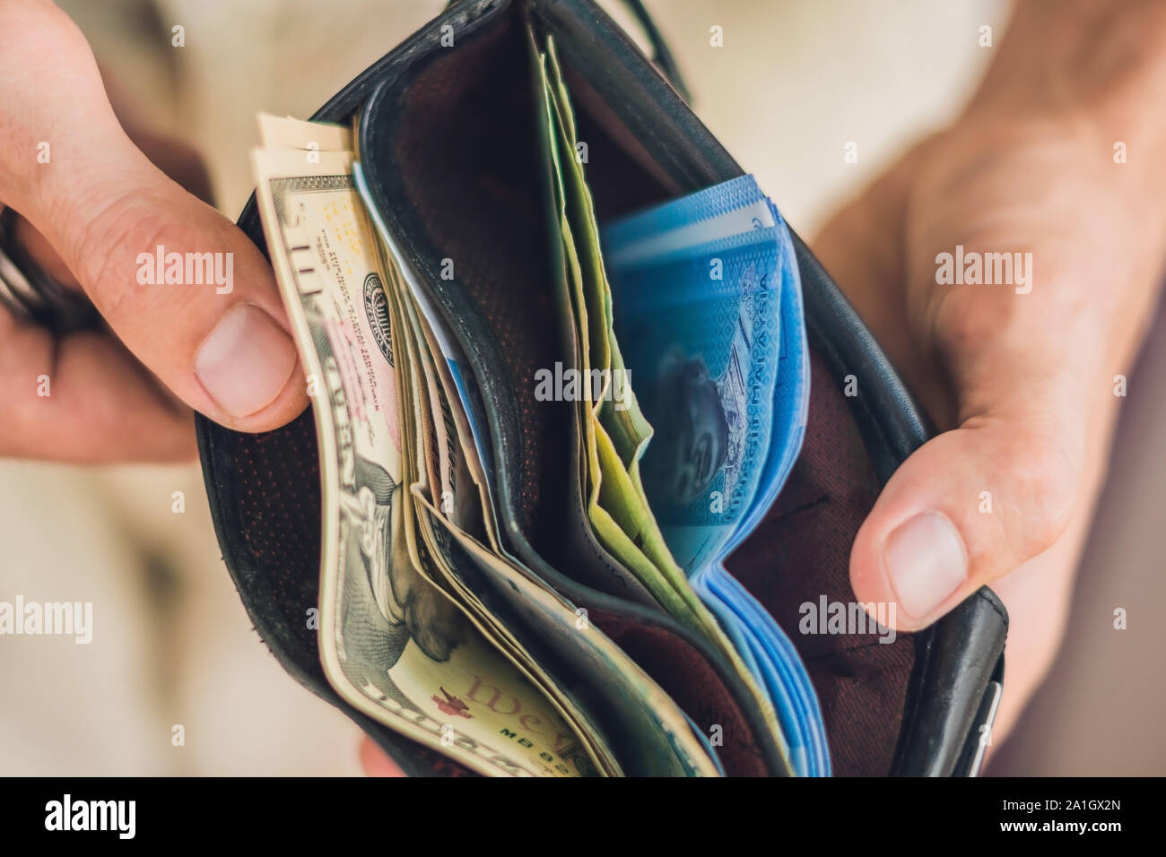 Banknotes of different countries in the wallet Stock Photo - Alamy