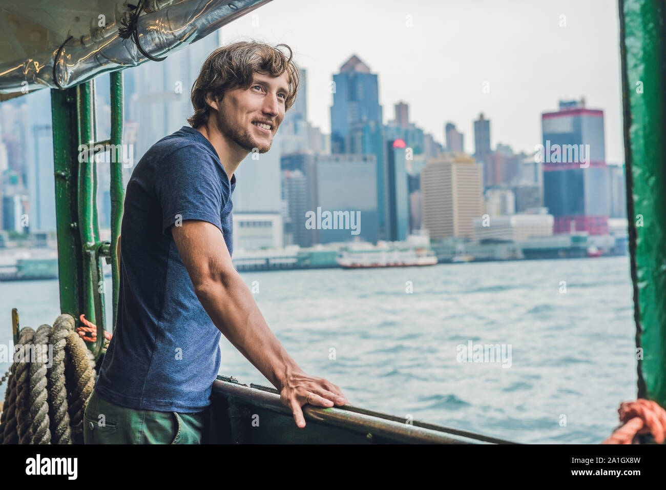 A young man on a ferry in Hong Kong Stock Photo - Alamy