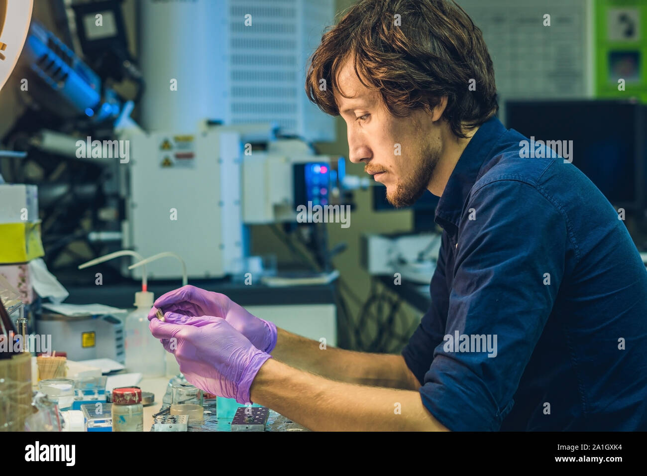 Scientist in a laboratory prepare a sample for an elecron microscopic ...