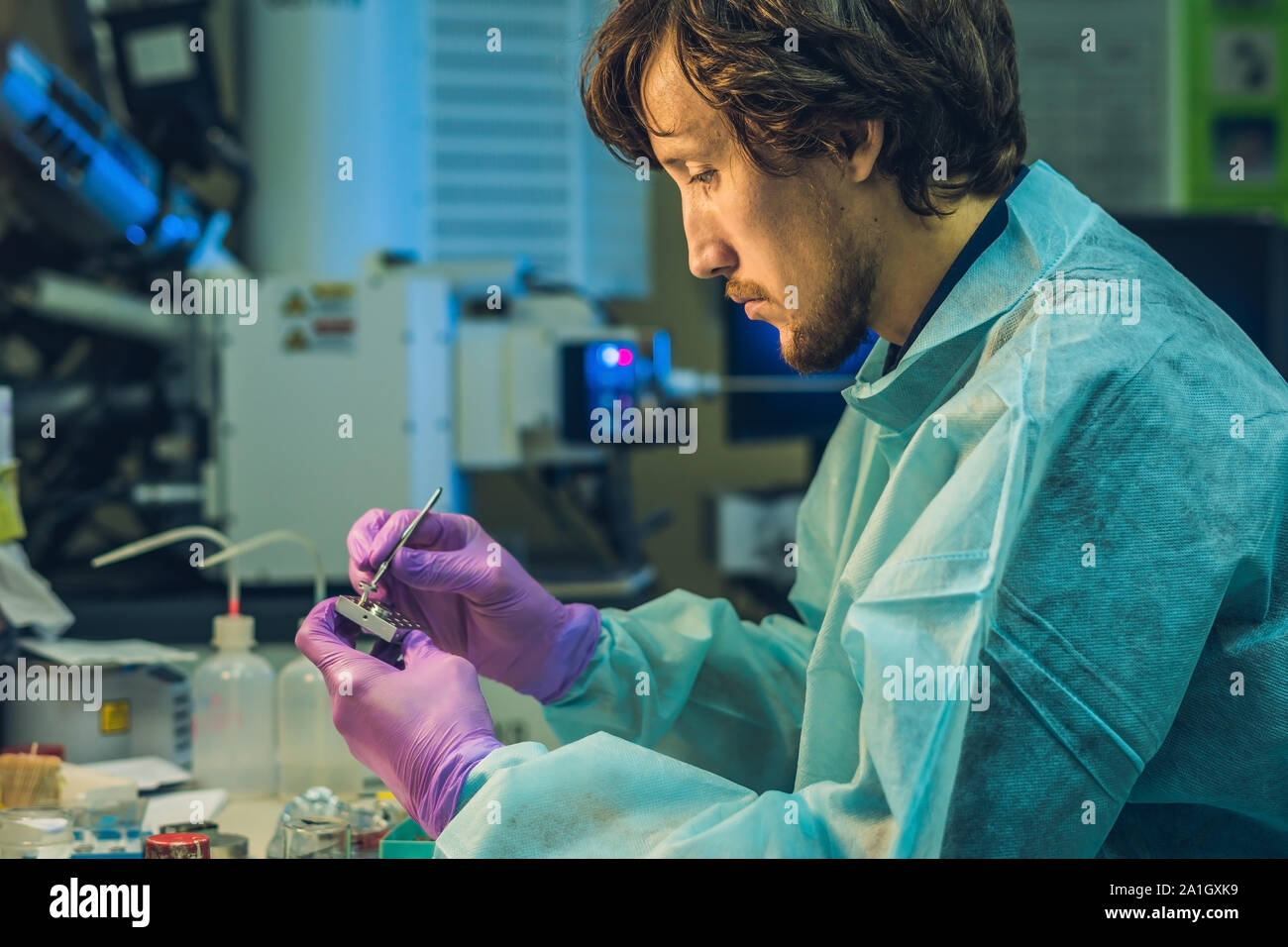 Scientist in a laboratory prepare a sample for an elecron microscopic ...