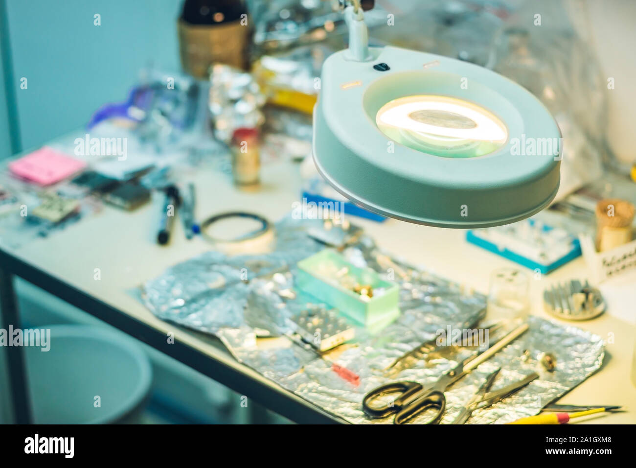 Sample preparation table with a lamp-magnifying glass in a laboratory ...