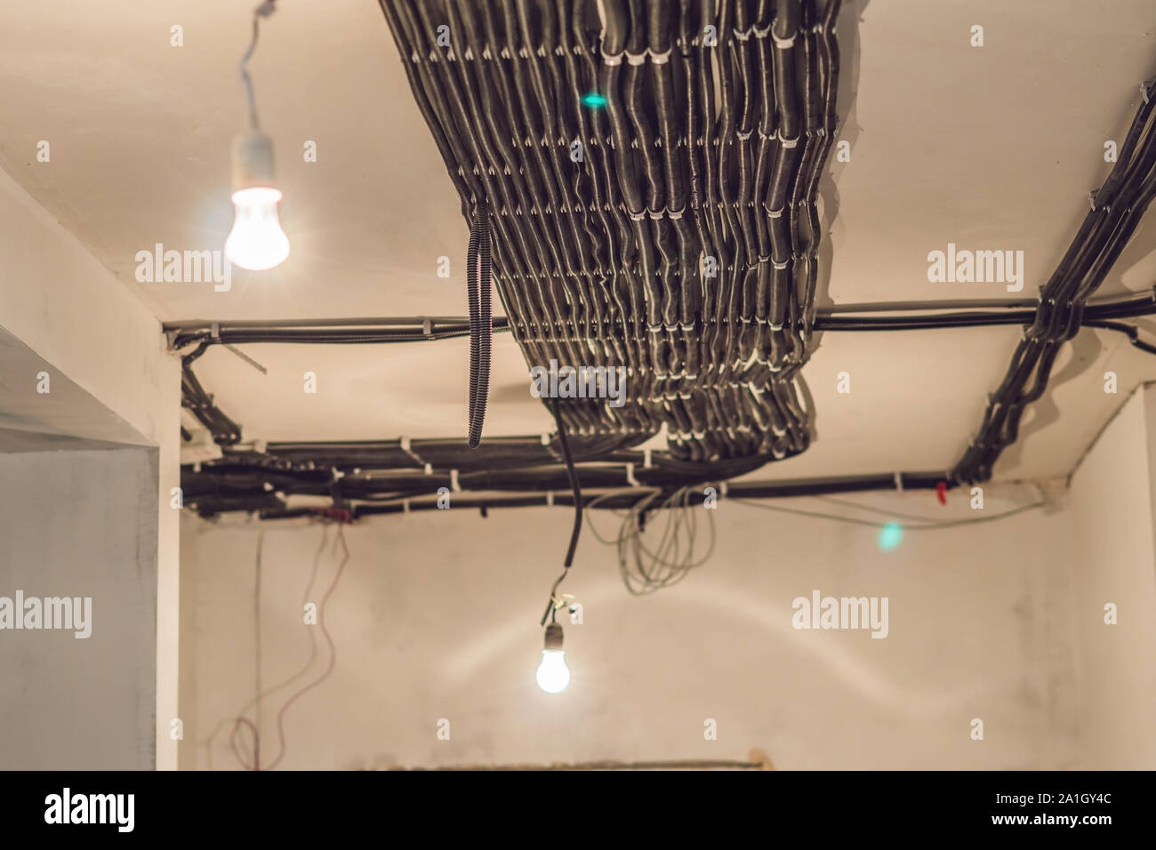 Ceiling frame made of metal profiles, electrical wires running across ...