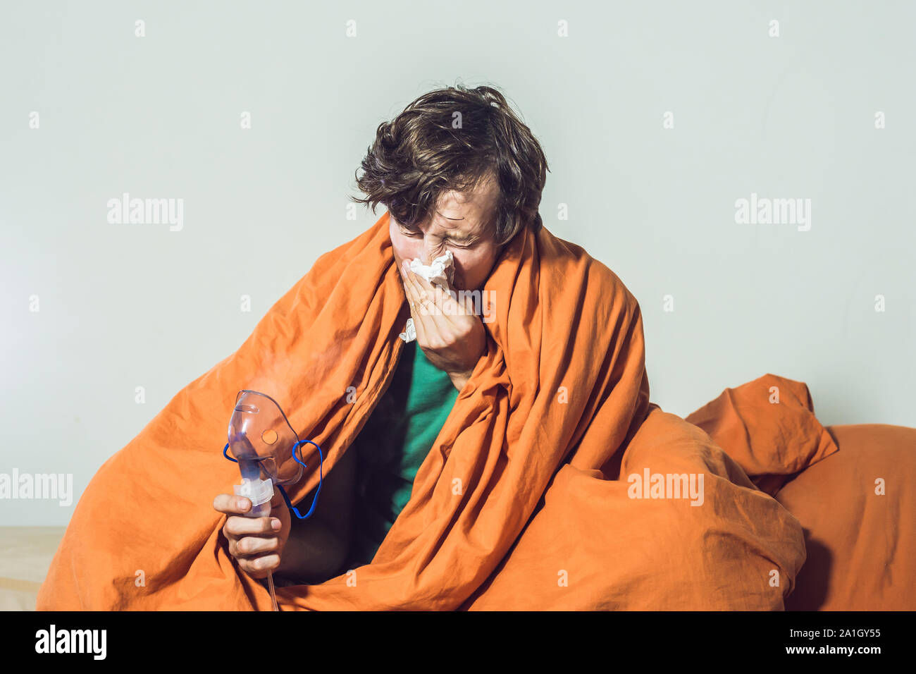 man with flu or cold symptoms making inhalation with nebulizer ...
