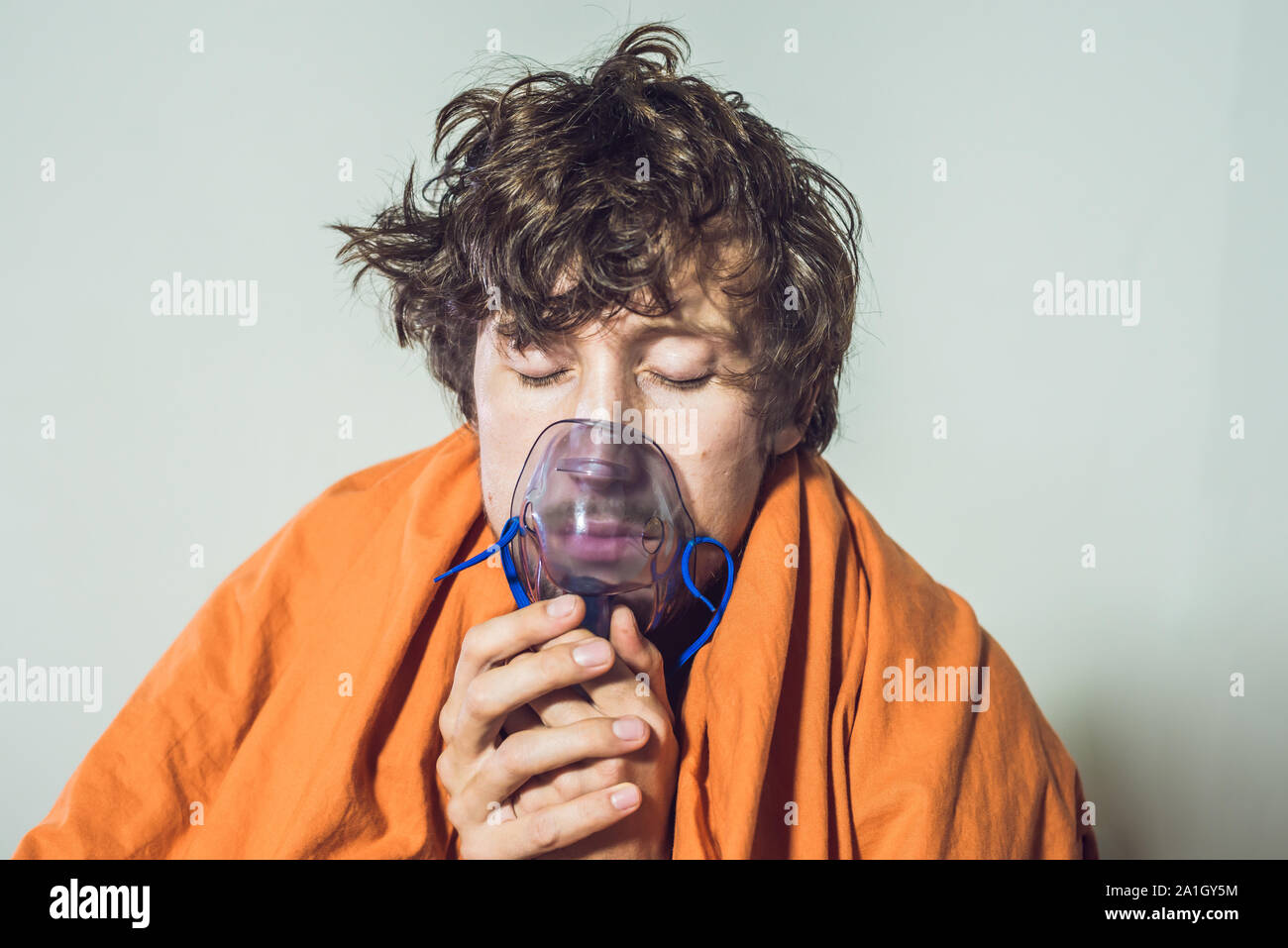 man with flu or cold symptoms making inhalation with nebulizer ...