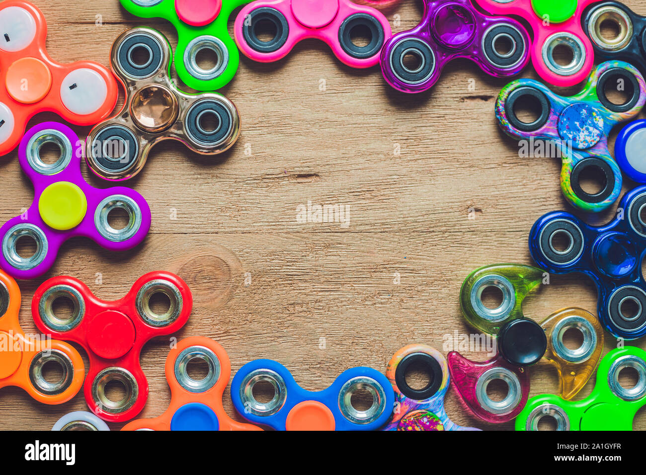 fidget spinners on wooden background with copy space, popular relaxing ...
