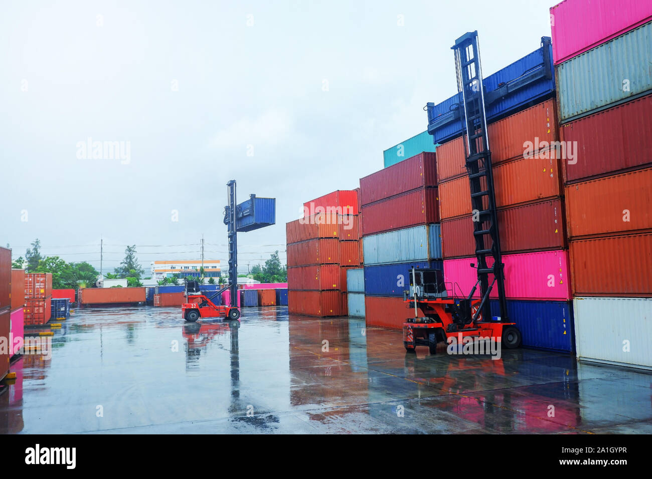 Two container handlers are storing containers up the stack. To wait for ...