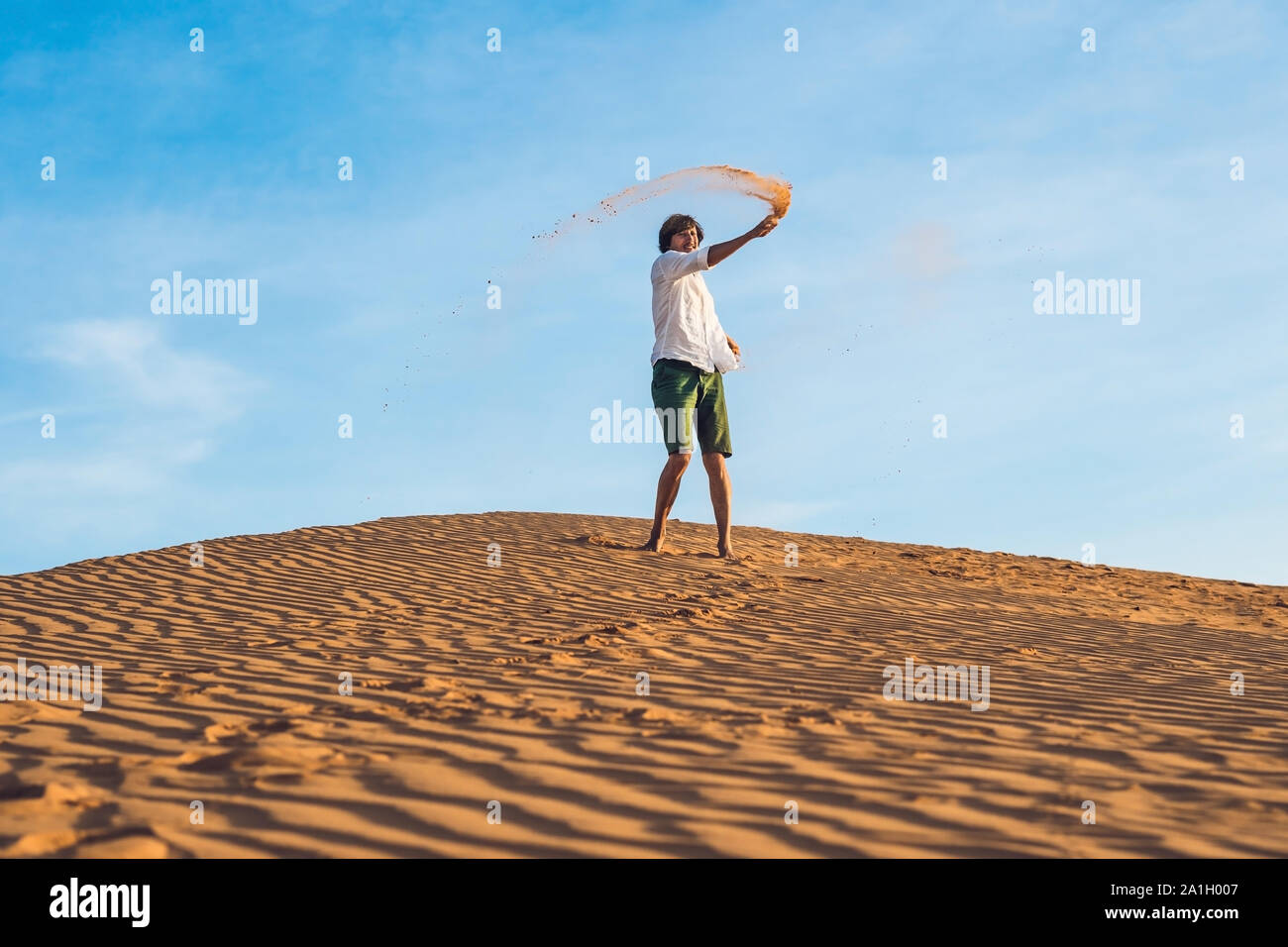 A man is kicking sand in a red desert. Splash of anger concept Stock ...