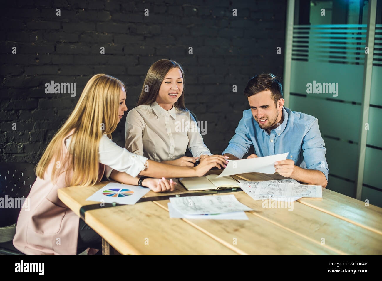 Young team of coworkers watching storyboard for shooting video in ...