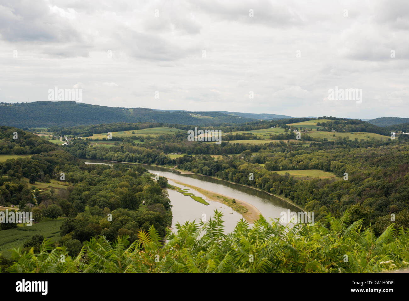 View of a river between farmland and rolling green hills in Wyalusing ...