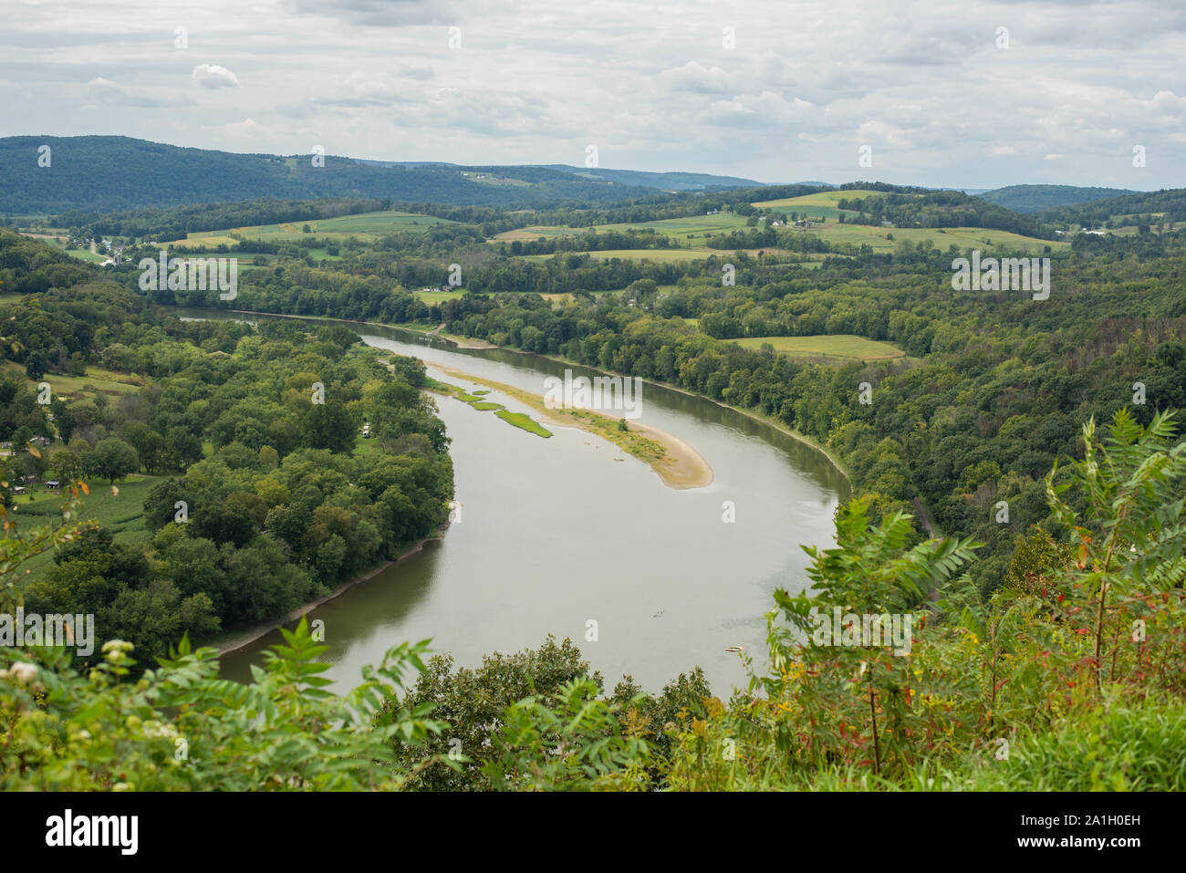 View of a river between farmland and rolling green hills in Wyalusing ...