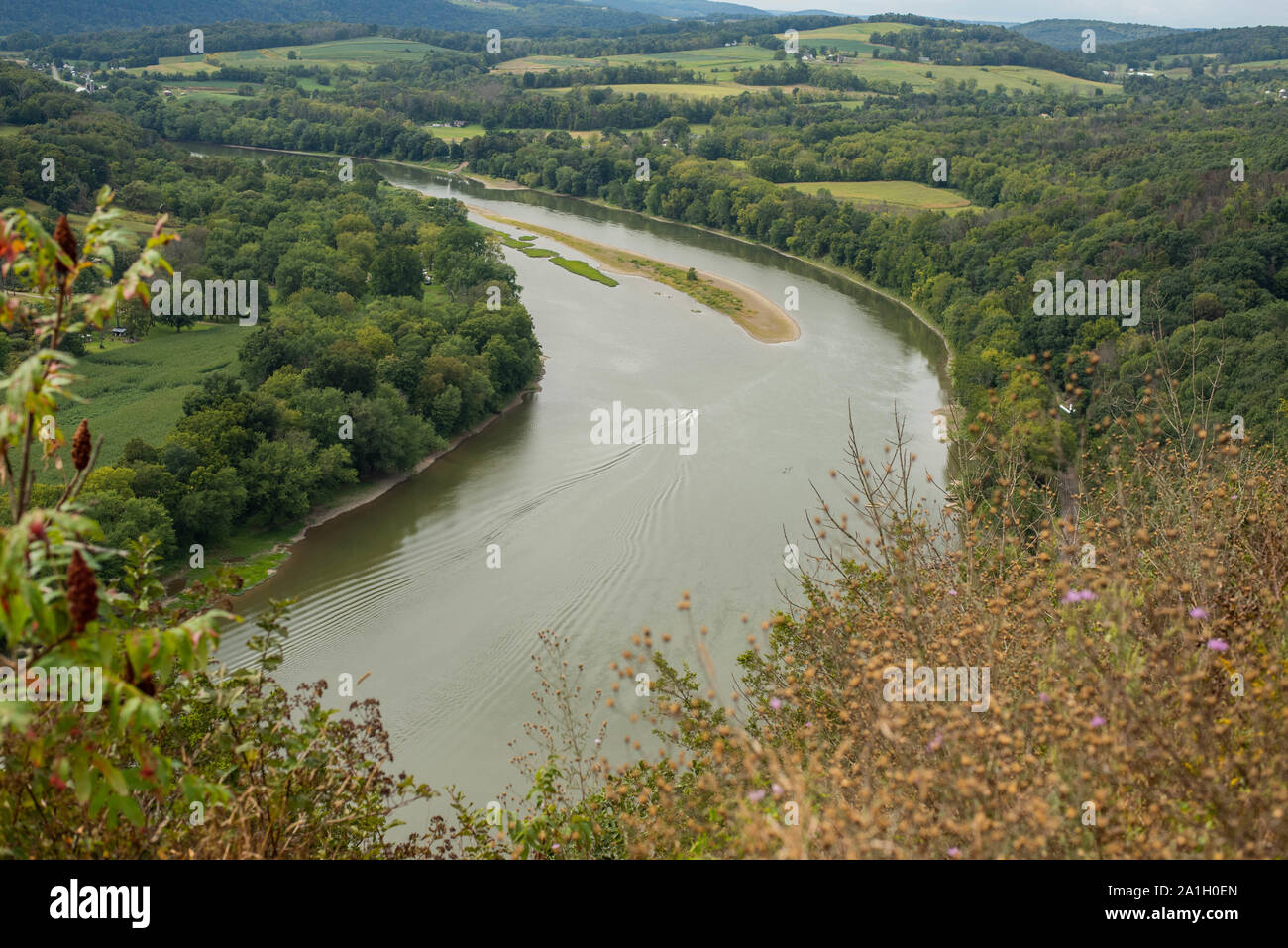 View of a river between farmland and rolling green hills in Wyalusing ...