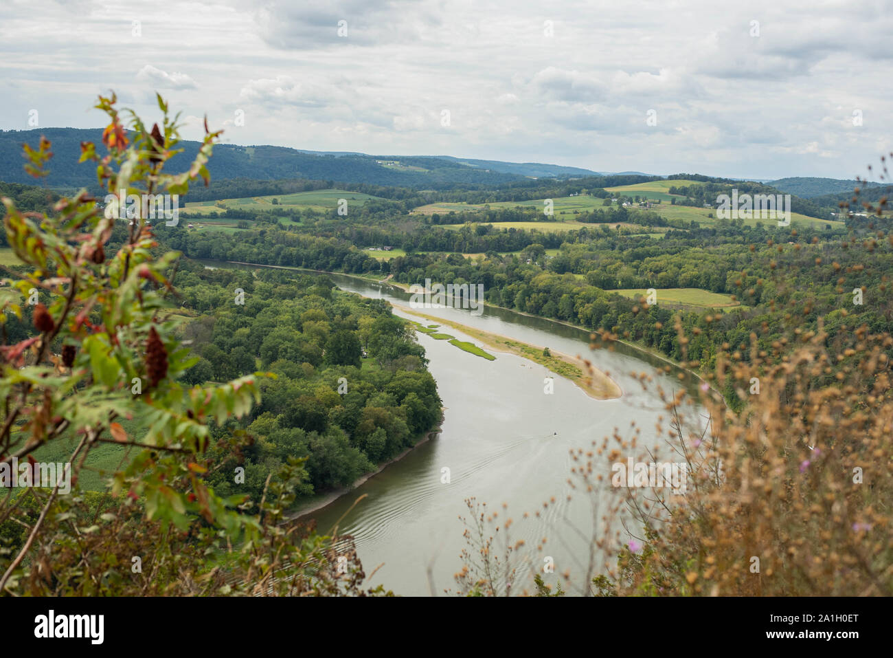 View of a river between farmland and rolling green hills in Wyalusing ...